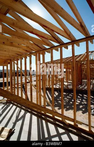 Construction of a wooden house on a sunny day in spring. New log house ...