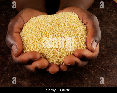MAN'S HANDS HOLDING COUSCOUS Stock Photo - Alamy