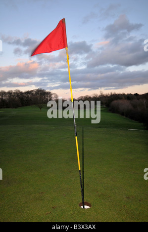 Flag on golf course late evening Stock Photo - Alamy