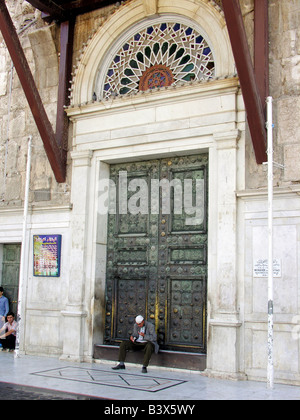 A man sits outside a mosque in Matadi, Monrovia, Liberia, West Africa ...
