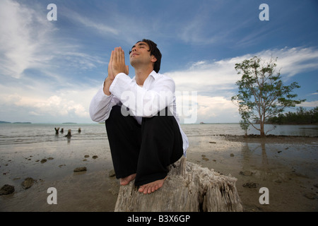 Man praying by the beach, Koh Lanta, Thailand Stock Photo - Alamy