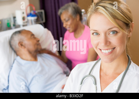 Smiling Doctor supporting a sick patient before medical procedures in a ...