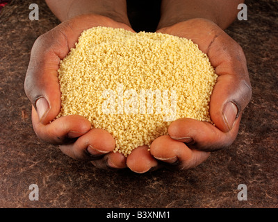 MAN'S HANDS HOLDING COUSCOUS Stock Photo - Alamy