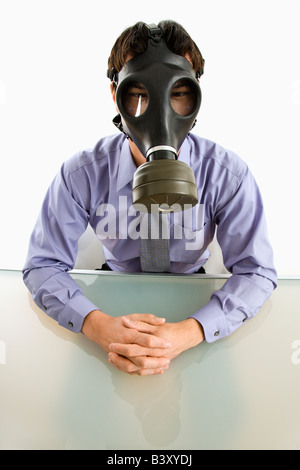 Asian businessman wearing face mask using smartphone in city street ...