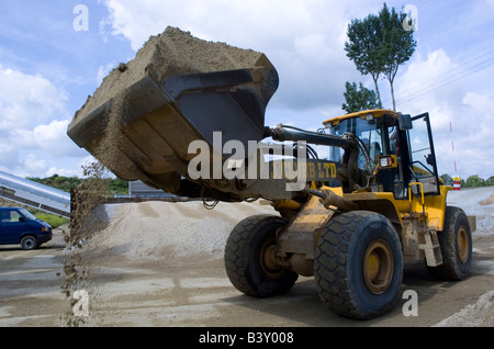 A loader tractor moves sand in the quarry Stock Photo - Alamy