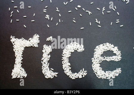 Rice grains spelling the word rice on a dark background Stock Photo - Alamy