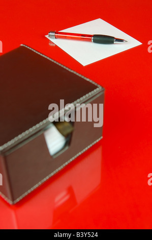 A note block isolated against a red background Stock Photo - Alamy