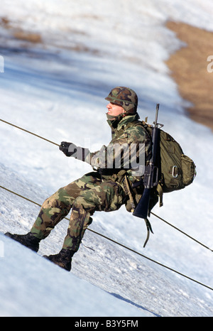Soldier climbing mountain Stock Photo - Alamy
