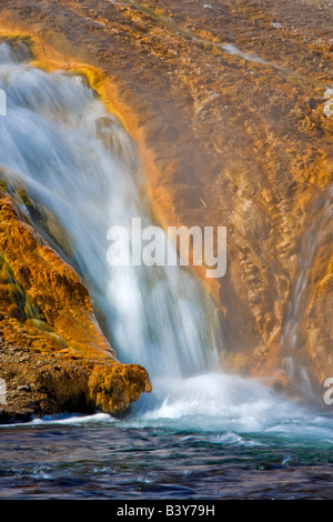 Hot springs waterfall flowing into the Firehole Rive Yellostone ...