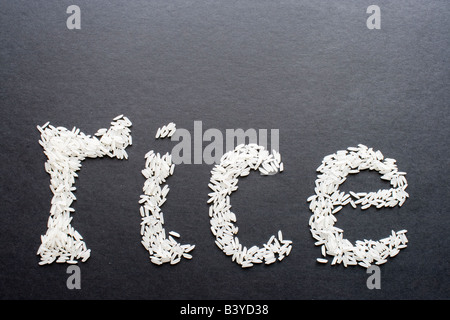 Rice grains spelling the word rice on a dark background Stock Photo - Alamy