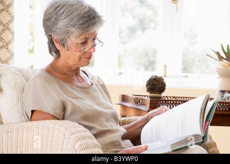 Woman relaxing reading book in car interior Stock Photo - Alamy