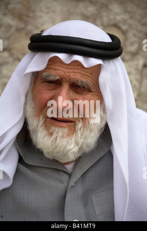 Arab man in ethnic clothes walking and carrying grocery bags and money ...