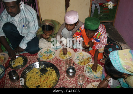 Extended Muslim family enjoying the Iftar evening meal during Ramadan ...