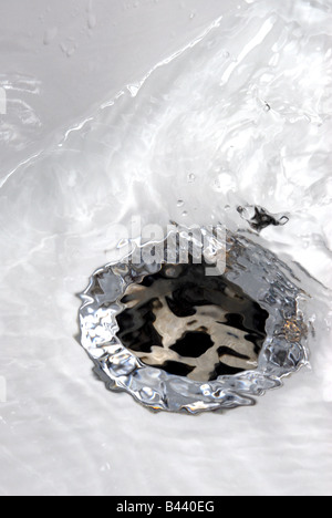 Running Water Draining Down the Plughole in Kitchen Sink Stock Photo ...