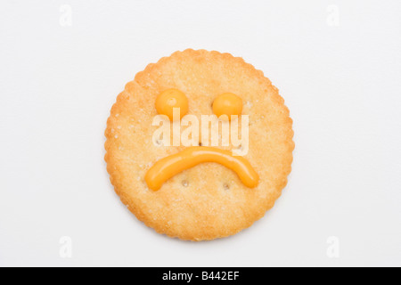 Sad face cracker Stock Photo - Alamy