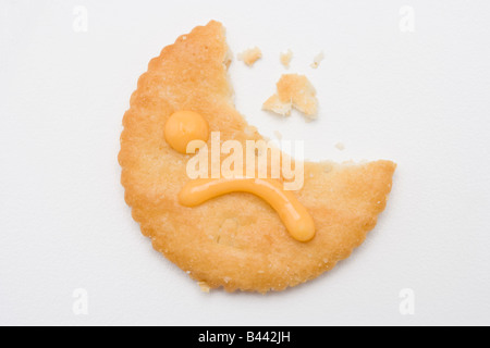 Sad face cracker Stock Photo - Alamy