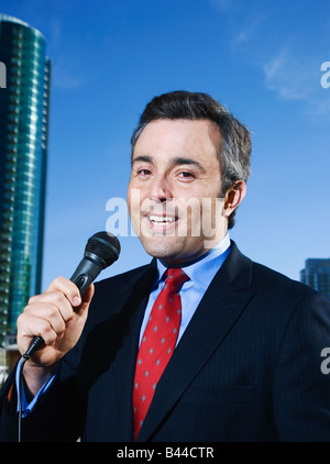 Hispanic man holding reporter microphone and clipboard angry and mad ...