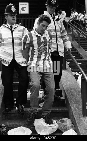 A man is led away by police during a Defend Our Juries protest in ...
