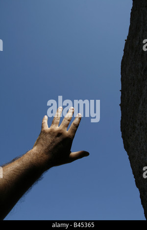 man's hand reaching out into clear blue sky Stock Photo - Alamy