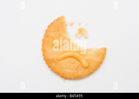Sad face cracker Stock Photo - Alamy