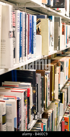 The aisles in a public library with shelves full of books isolated over ...