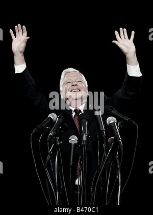 Male politician with hands raised Stock Photo - Alamy
