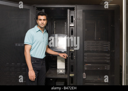 Young indian technician working on washing machine yawning tired ...