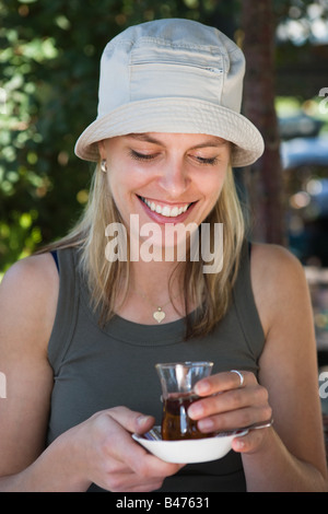 Young middle east woman holding makeup brush and blush making fish face ...