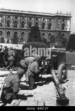 VIENNA 1945 Red Army soldiers stand guard beside a poser of Stalin ...