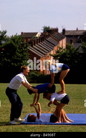 Teacher showing exercise on mat to pupils during gym class in primary ...