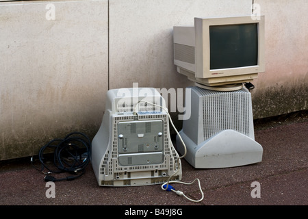 Three old obsolete computer screen monitors discarded as junk on the ...