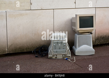 Three old obsolete computer screen monitors discarded as junk on the ...