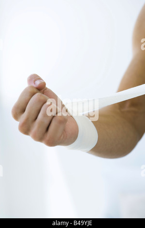 Man wrapping gauze around injured finger, cropped view Stock Photo - Alamy