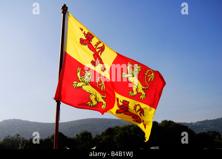 The yellow and red Scottish Lion Rampant flag flying against a blue sky ...