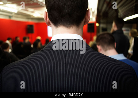 Job seekers listen to information about employment from a recruiter ...