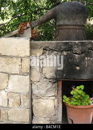 EUROPE GREECE AN OLD FASHIONED STILL FOR DISTILLING RAKI WITH A LOOM IN ...
