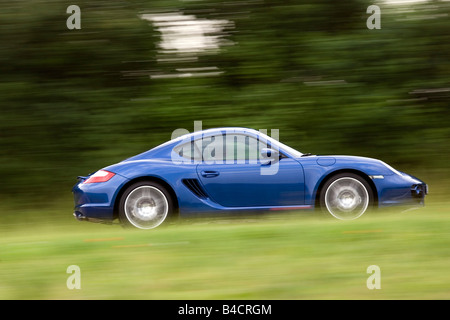 Porsche Cayman, model year 2005-, blue moving, diagonal from the back ...