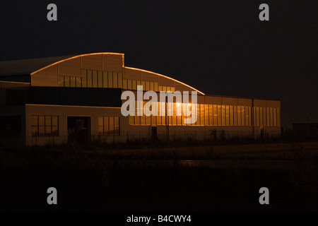 Factory on the outskirts of Kosching with the sunset reflecting in its ...