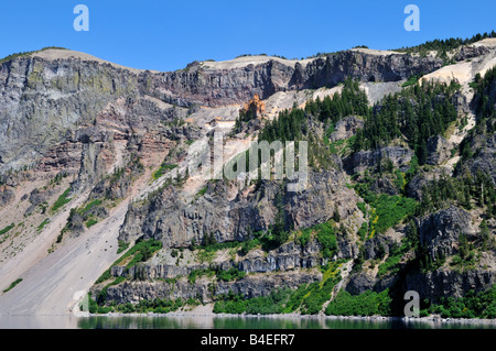 The Pumice castle on a rocky cliff of the Crater Lake rim. The Crater ...