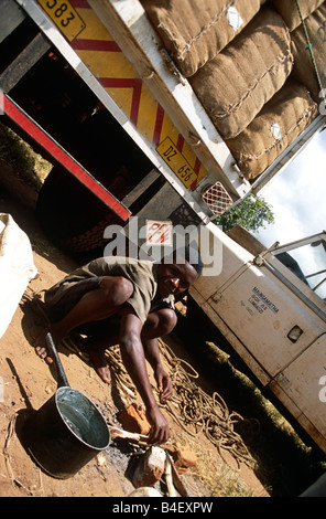 Young homeless man on light background Stock Photo - Alamy