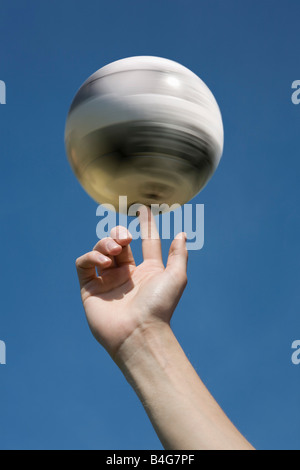 Hand and spinning soccer ball Stock Photo - Alamy