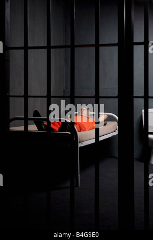 Man lying in prison cell Stock Photo - Alamy