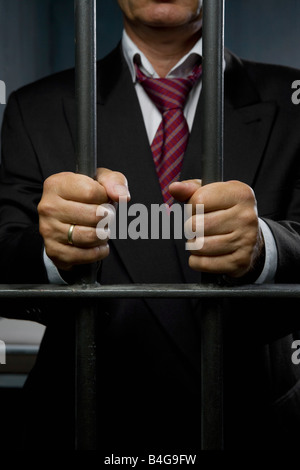 Man behind bars of jail cell Stock Photo - Alamy