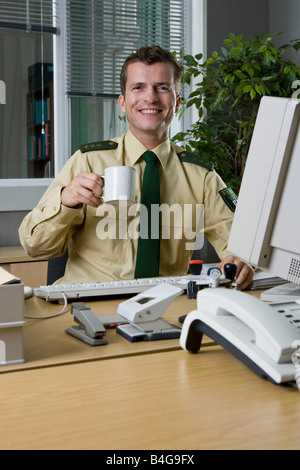 Police officer in police station working on the computer, on a case or ...