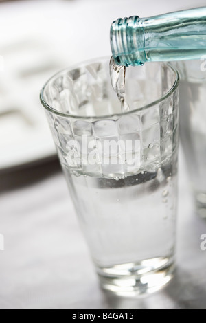 Bottled Water Pouring into Glass Stock Photo - Alamy