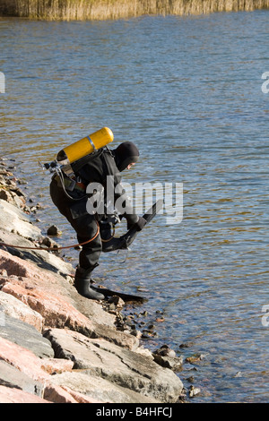 Scuba diver getting ready for scuba diving on the beach. Setting up ...