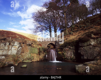 Three Shire Heads. A waterfall and packhorse stone bridge at Three ...