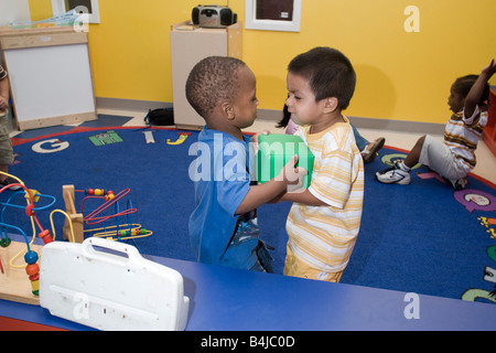 Kids fighting over a toy Stock Photo - Alamy