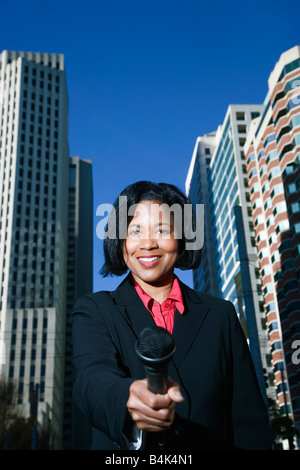 happy female african news reporter working Stock Photo - Alamy