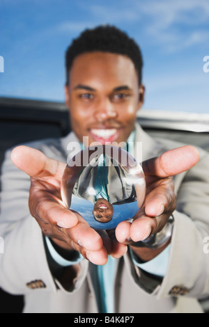 one man holding a crystal ball Stock Photo - Alamy